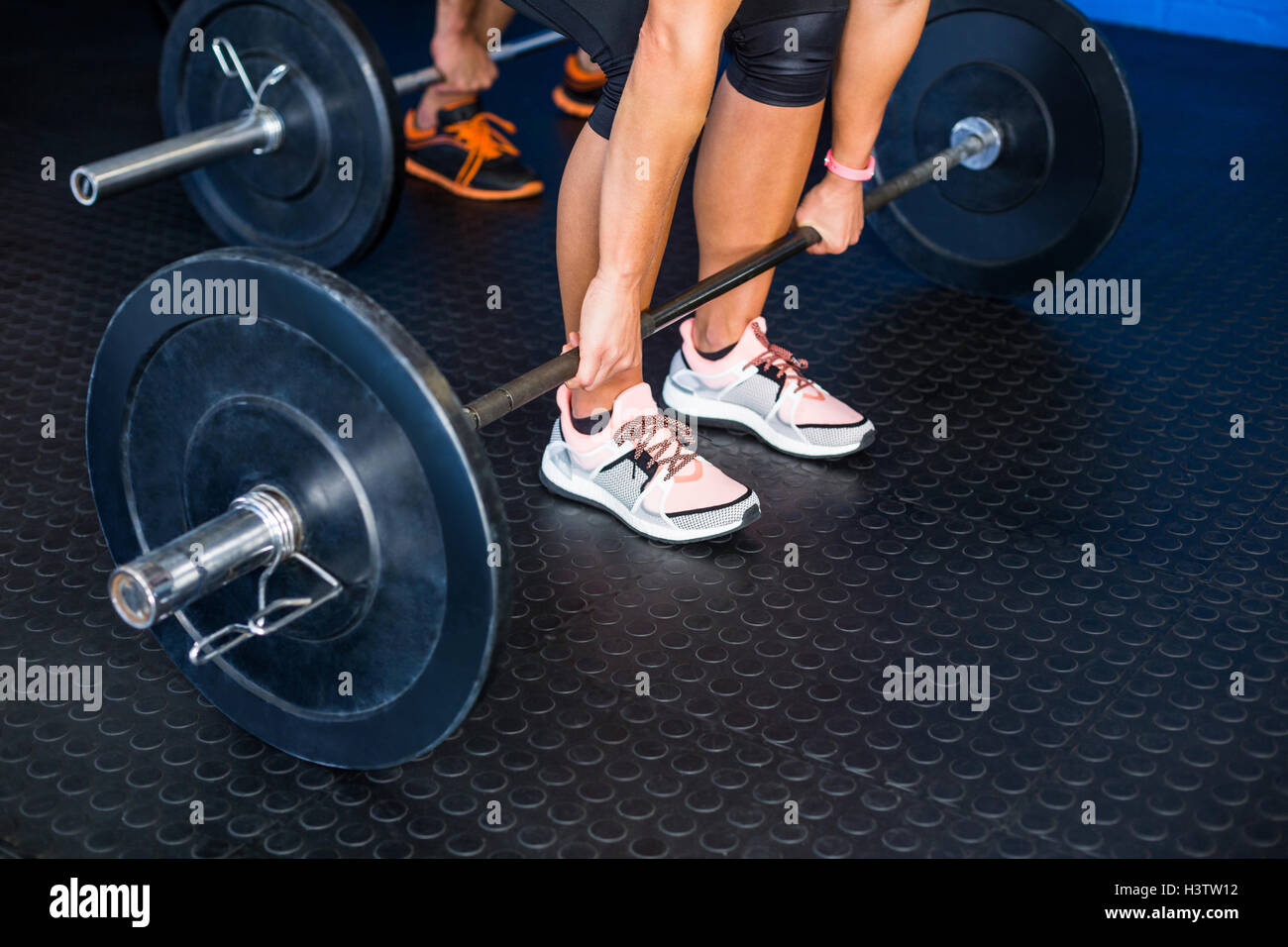 People lifting barbell at gym Stock Photo - Alamy