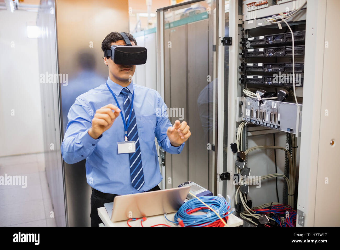 Technician using visual reality headset Stock Photo - Alamy