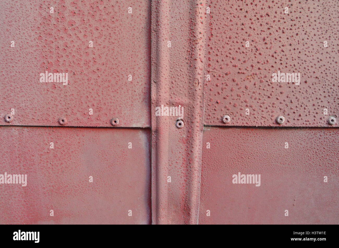 Sheet metal with red dots. Photo of a sheet metal with a red background ...