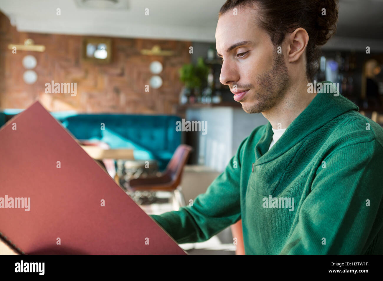 Man looking at menu Stock Photo - Alamy