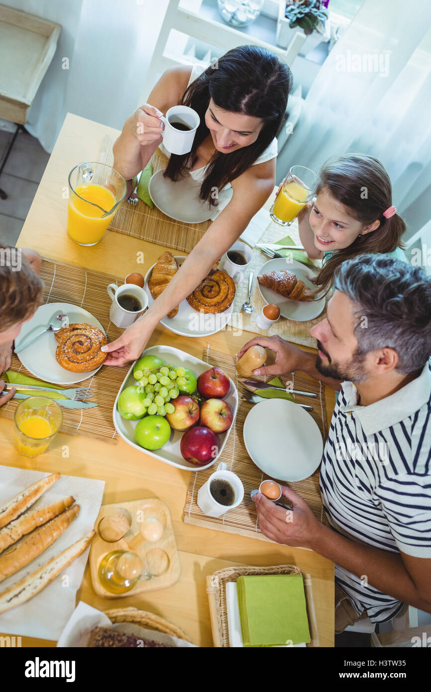 Happy family having breakfast at home Stock Photo - Alamy