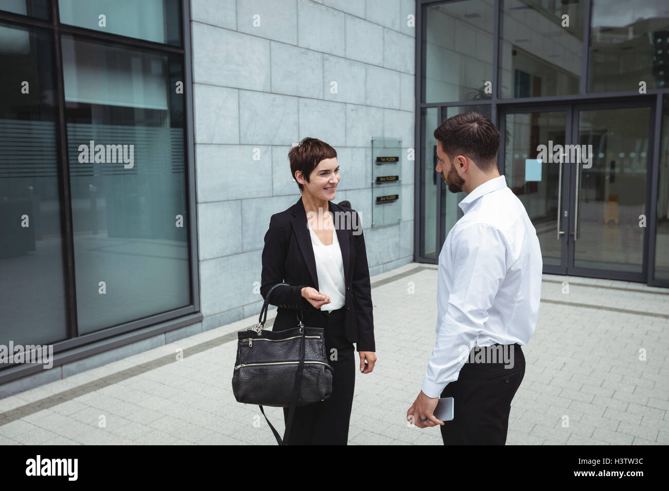 Businesspeople interacting with each other Stock Photo - Alamy