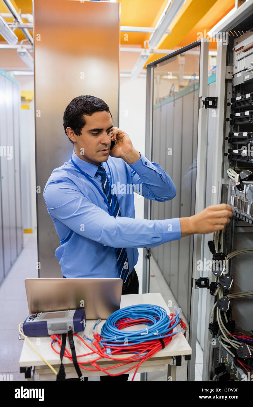 Technician talking on mobile phone Stock Photo - Alamy