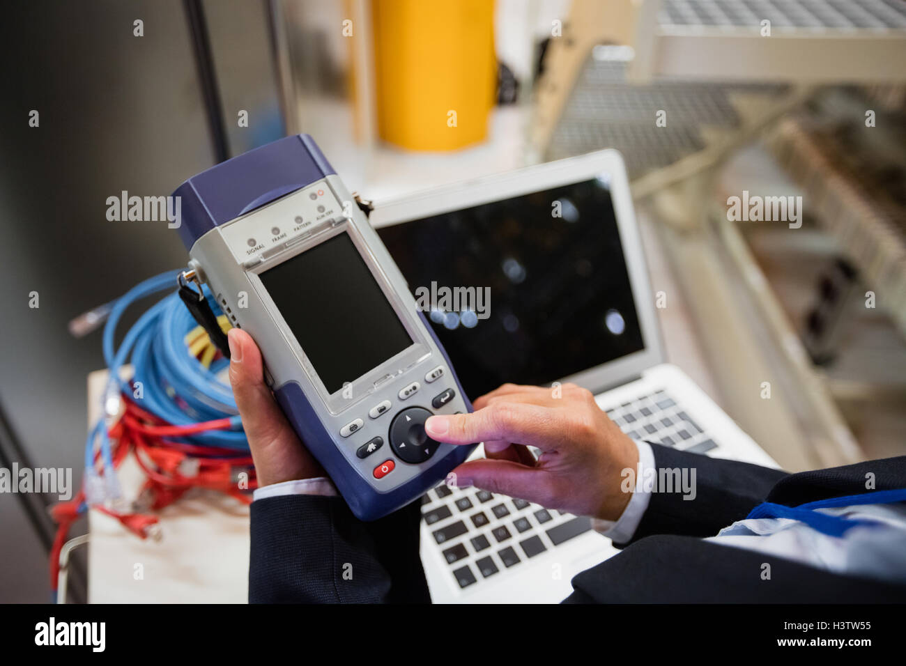 Technician using digital cable analyzer Stock Photo - Alamy