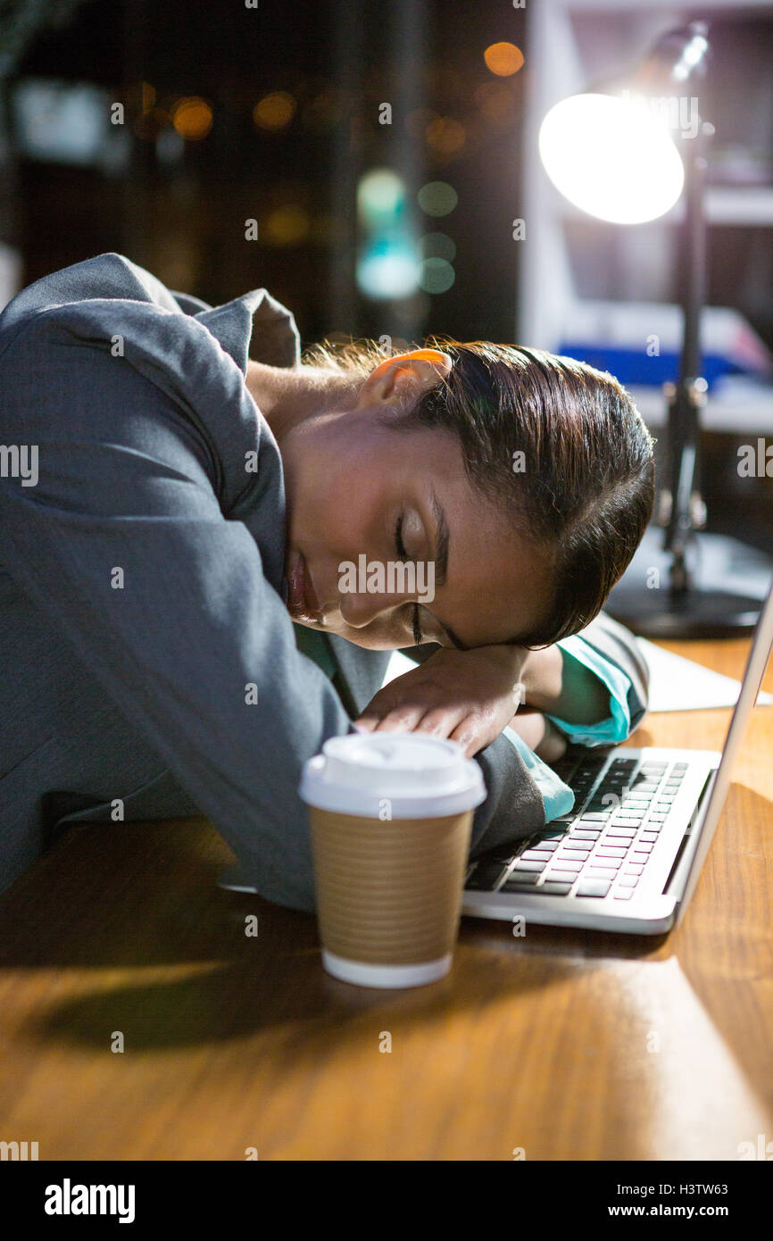 Businesswoman sleeping while working in office Stock Photo - Alamy