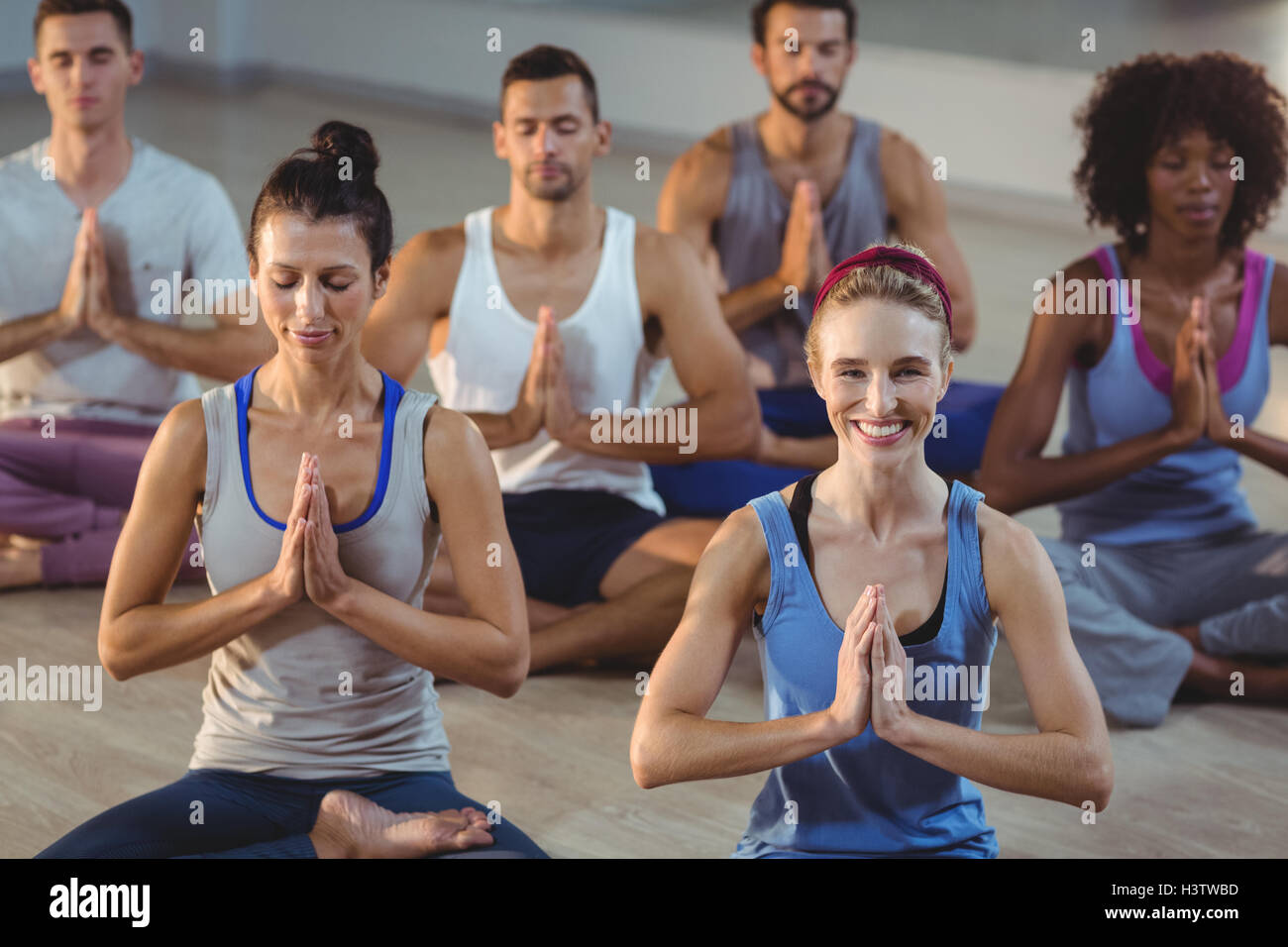 Group of people performing yoga Stock Photo - Alamy