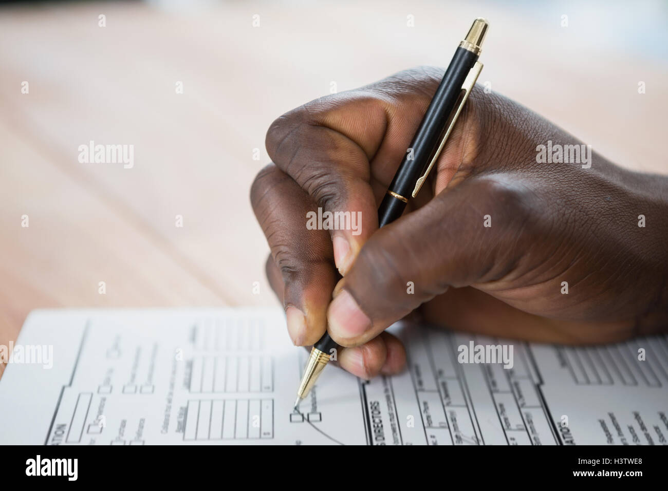 Hands of a man signing document Stock Photo - Alamy