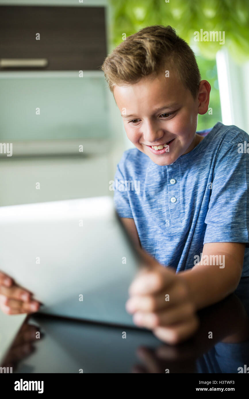 Boy using digital tablet at home Stock Photo - Alamy