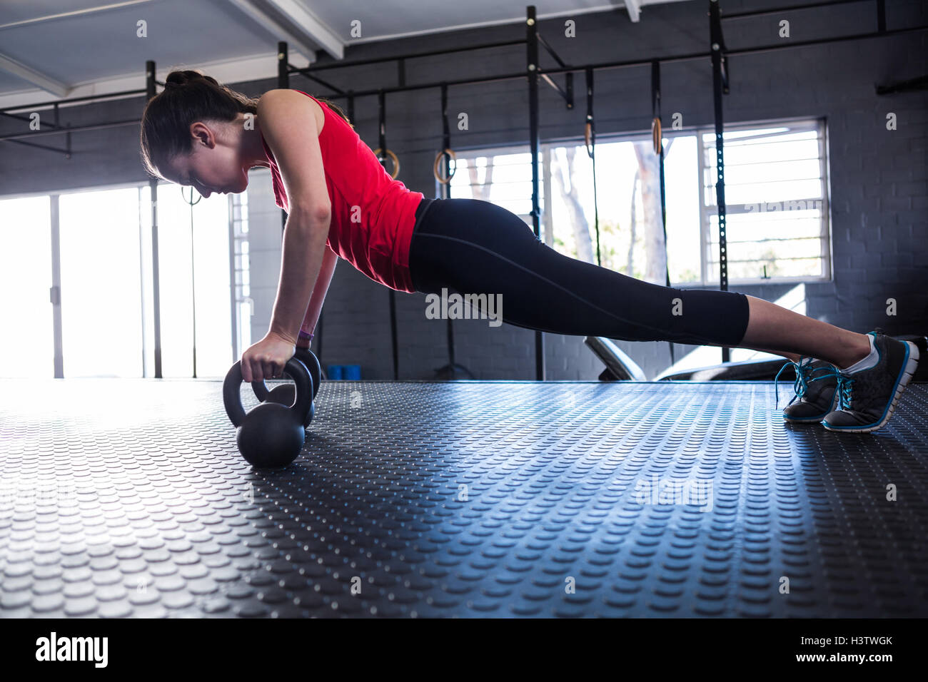 Sporty female athlete doing push-ups in gym Stock Photo - Alamy