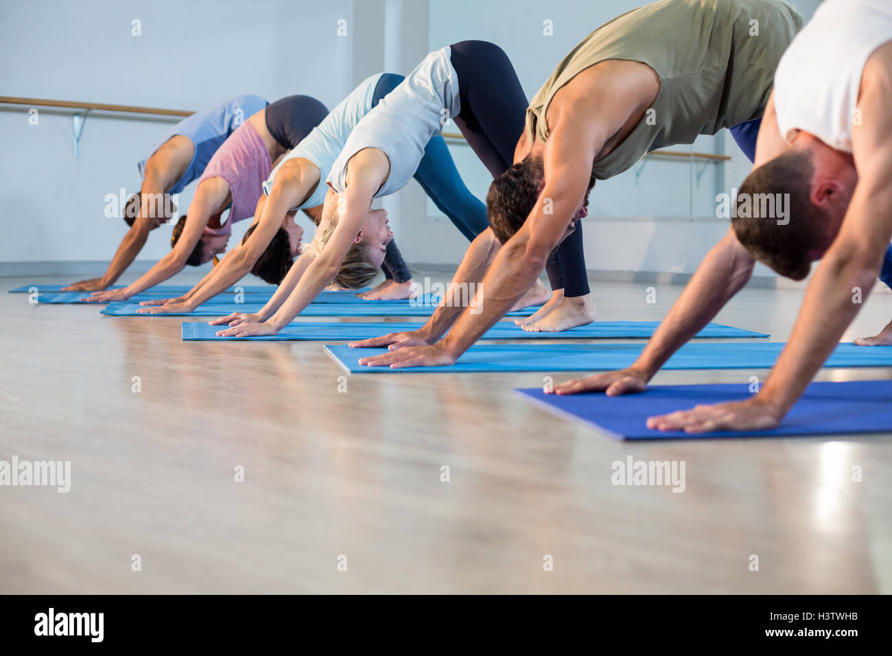 Group of people performing yoga Stock Photo - Alamy