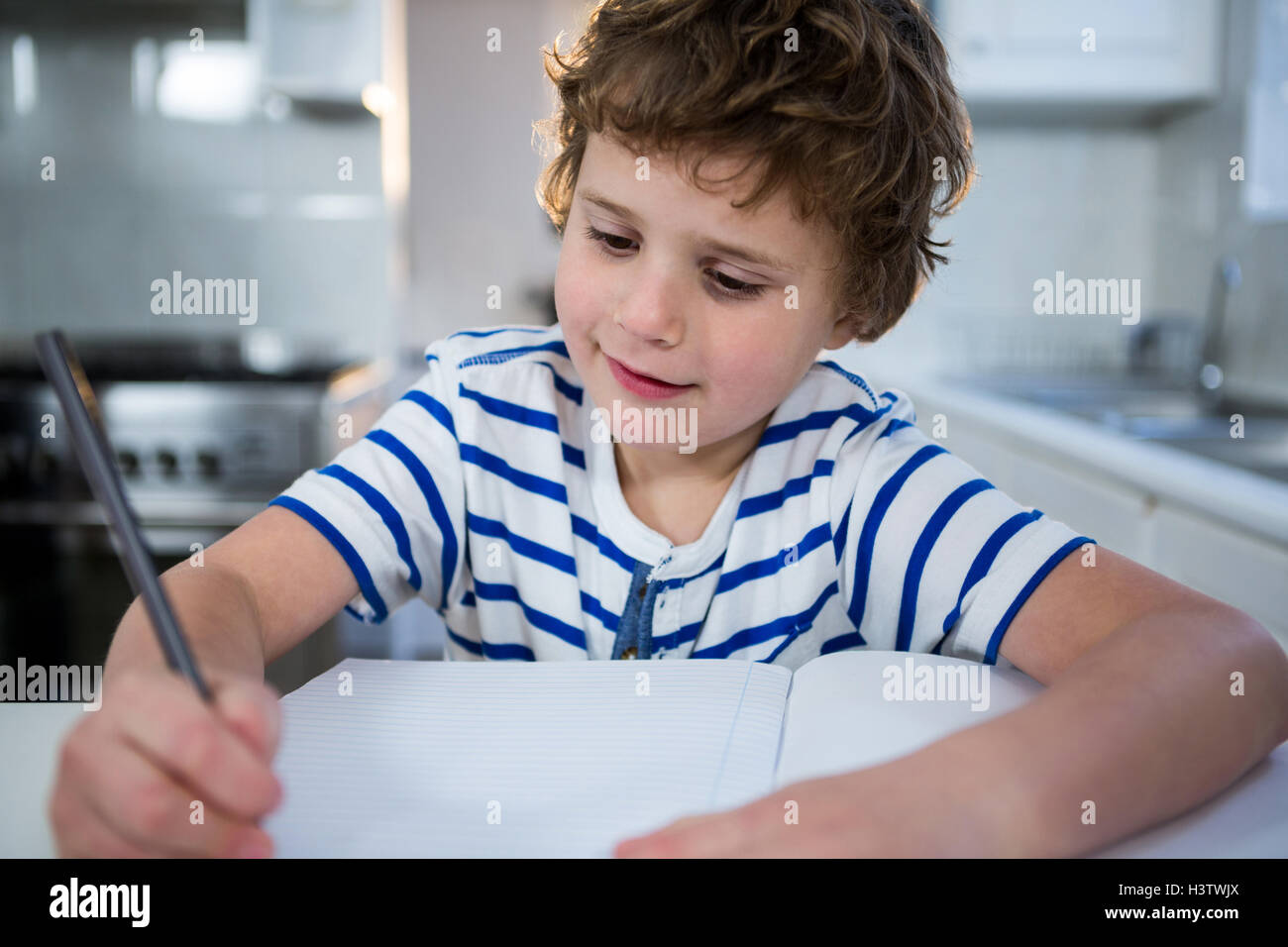 Boy doing his homework Stock Photo - Alamy