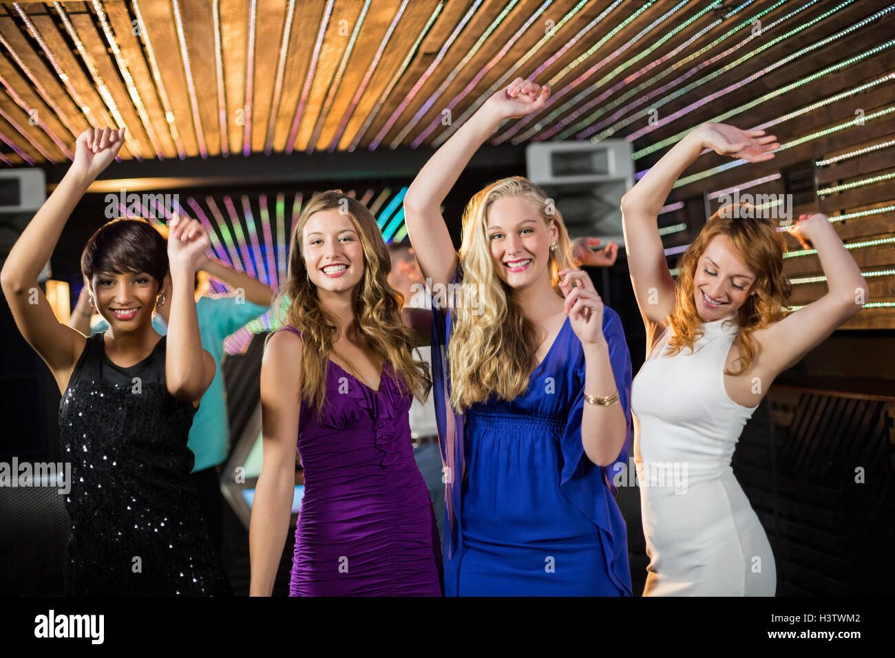 Group of smiling friends dancing on dance floor Stock Photo - Alamy