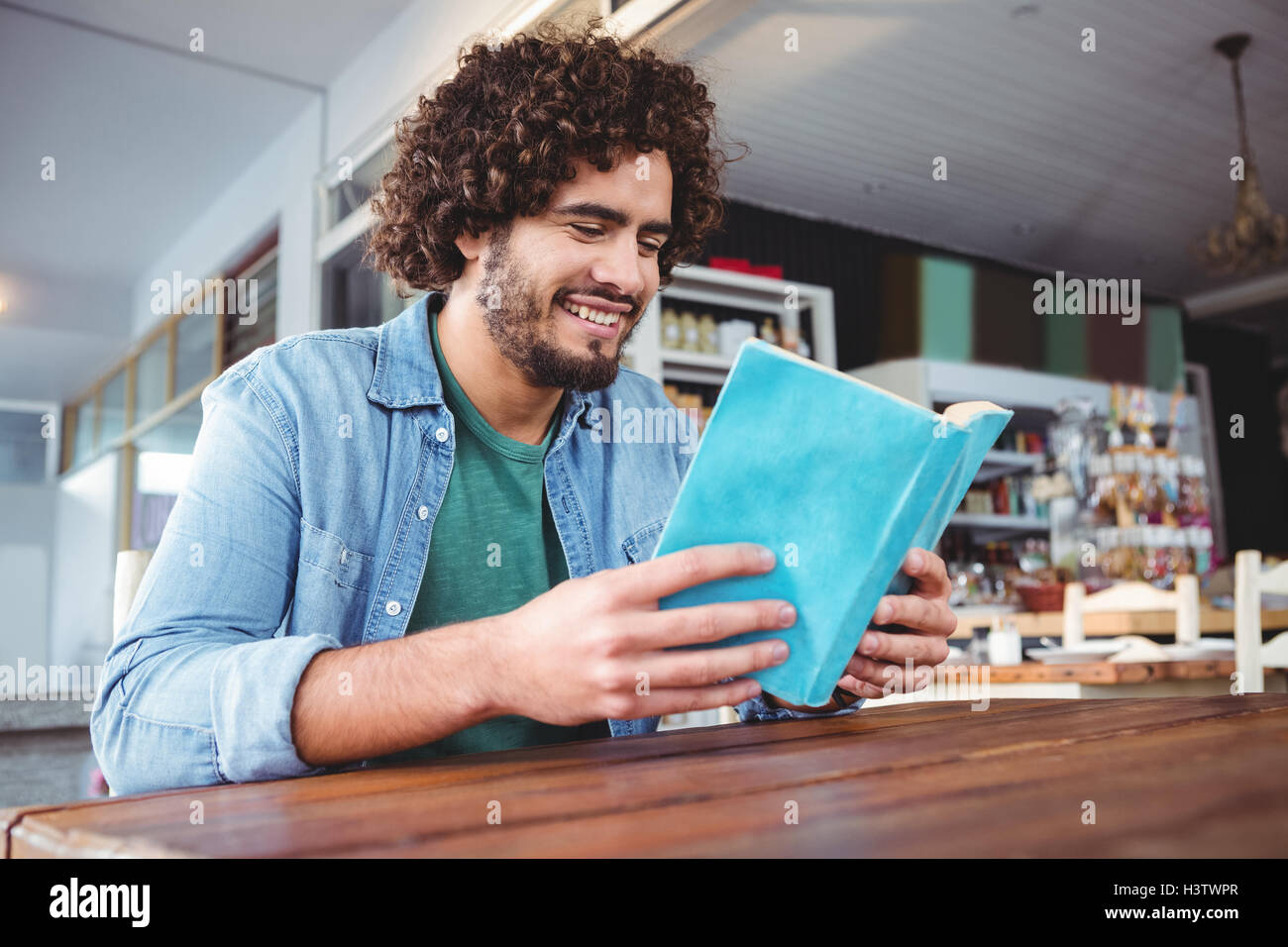 Happy man reading book hi-res stock photography and images - Alamy