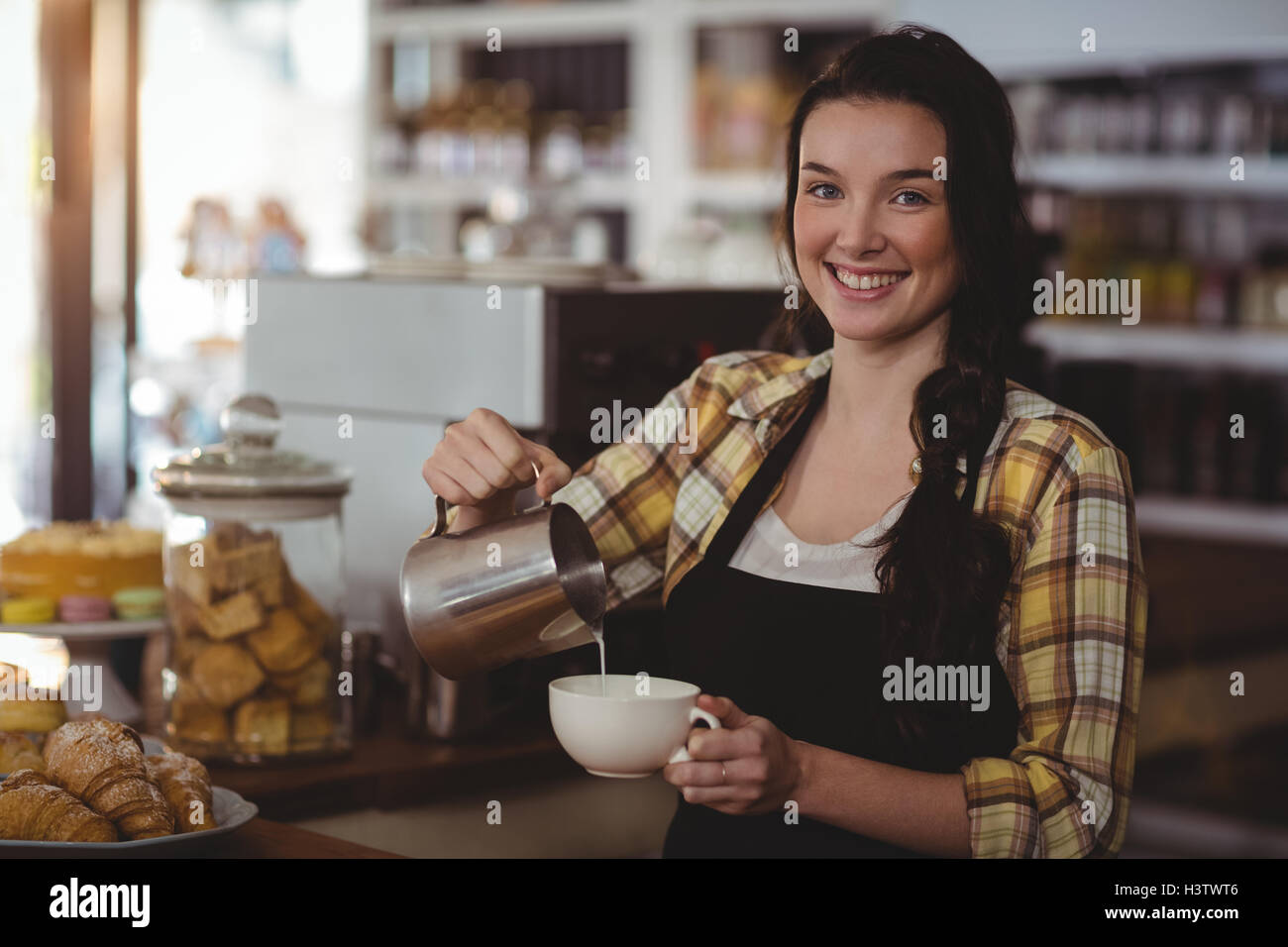 Portrait of waitress making cup of coffee at counter Stock Photo - Alamy