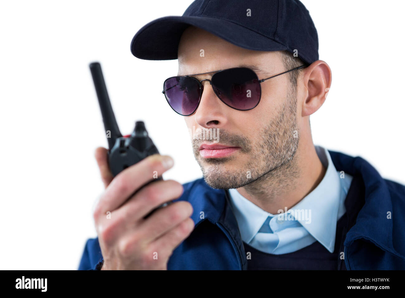 Handsome security officer talking on walkie-talkie Stock Photo - Alamy