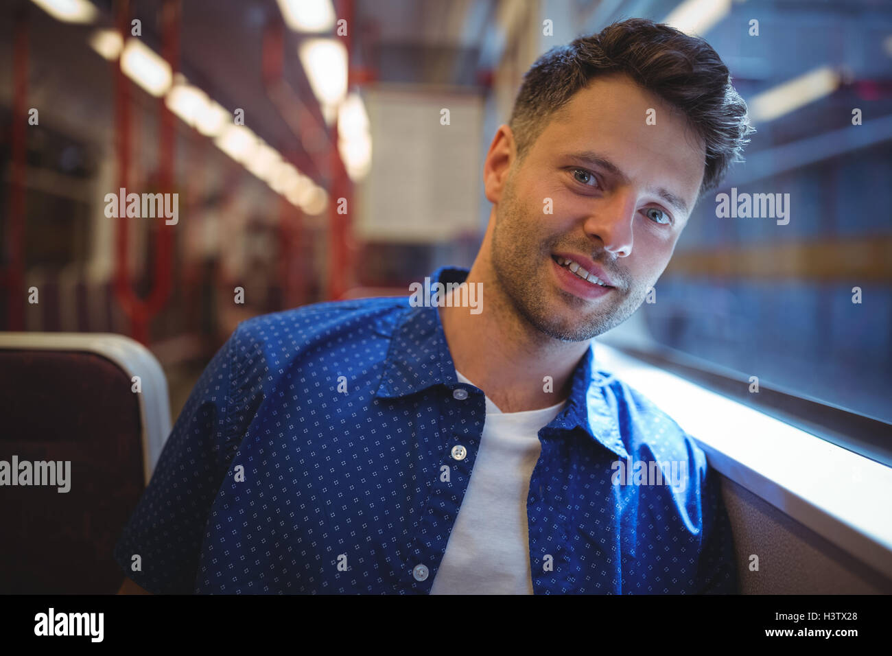 Handsome man looking through window Stock Photo - Alamy