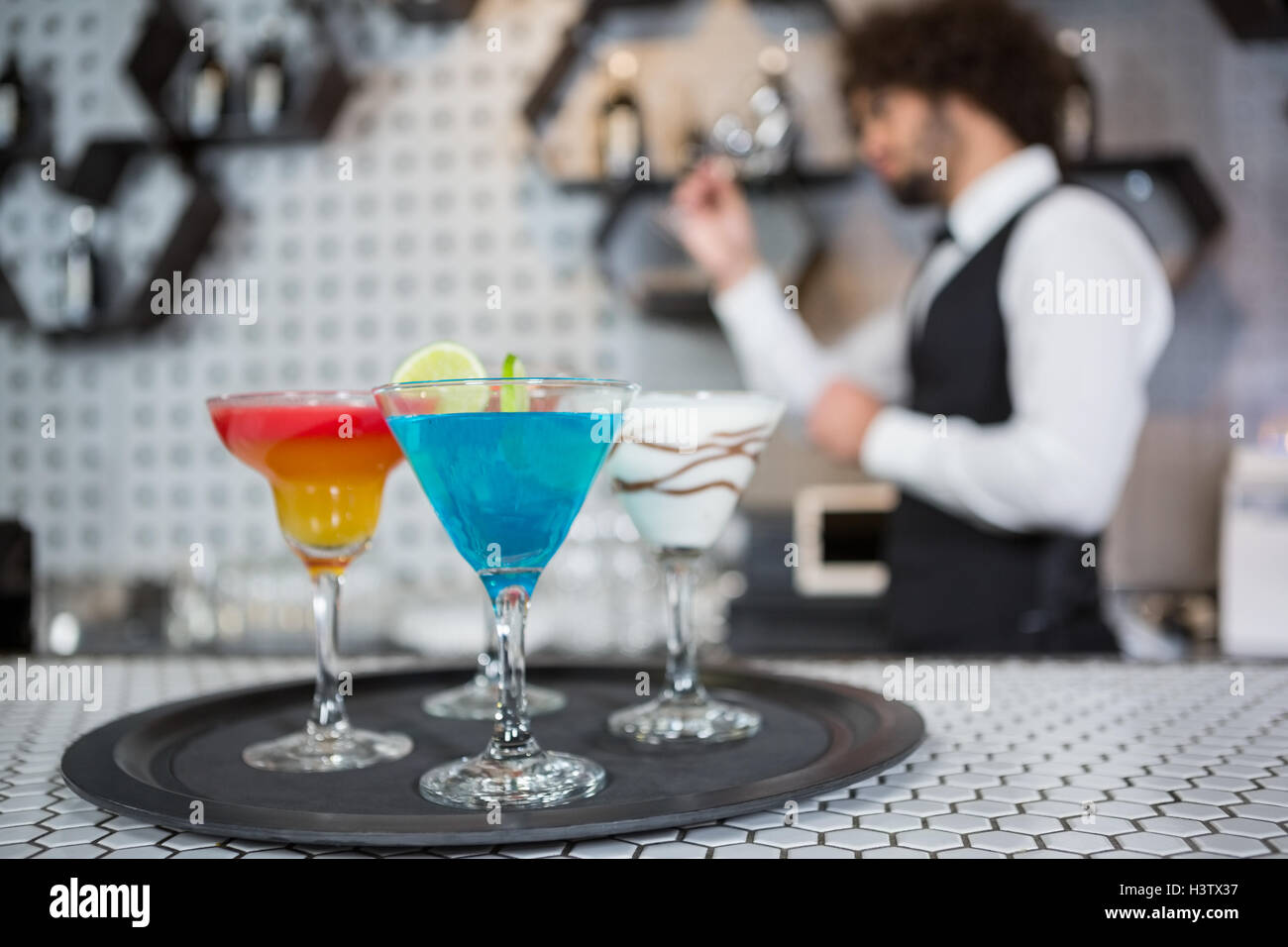 Various cocktails on a serving tray in bar counter Stock Photo - Alamy
