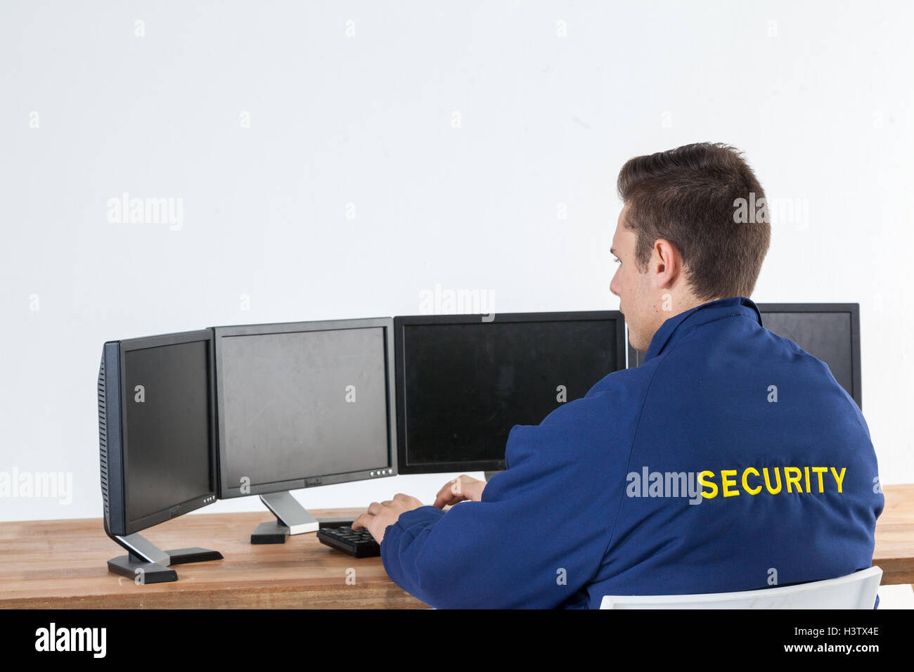 Security officer using computer Stock Photo - Alamy