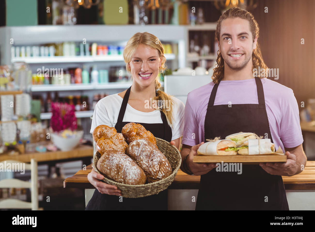 Portrait of waiter and waitress holding a tray of bread and meal Stock ...