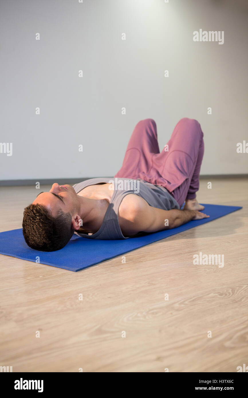 Man in yoga corpse pose Stock Photo - Alamy