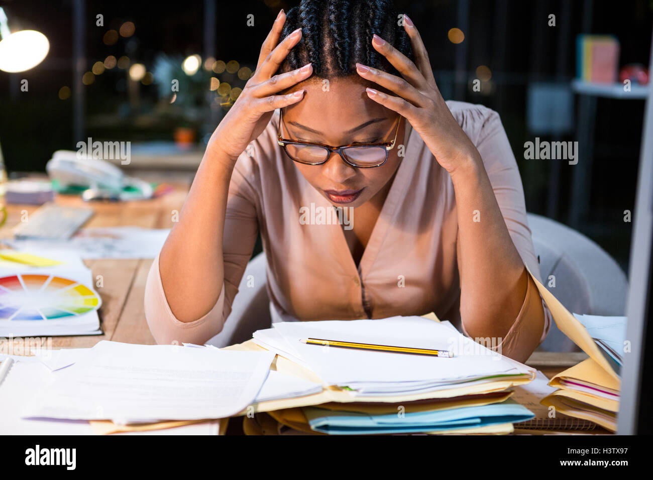 Stressed businesswoman sitting at her desk Stock Photo - Alamy