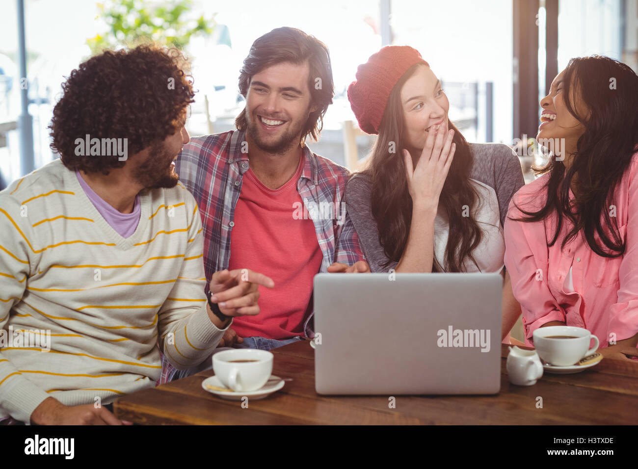 Laughing friends enjoying coffee with laptop Stock Photo - Alamy