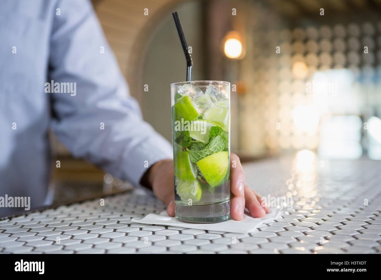 Close-up of man holding glass of gin Stock Photo - Alamy