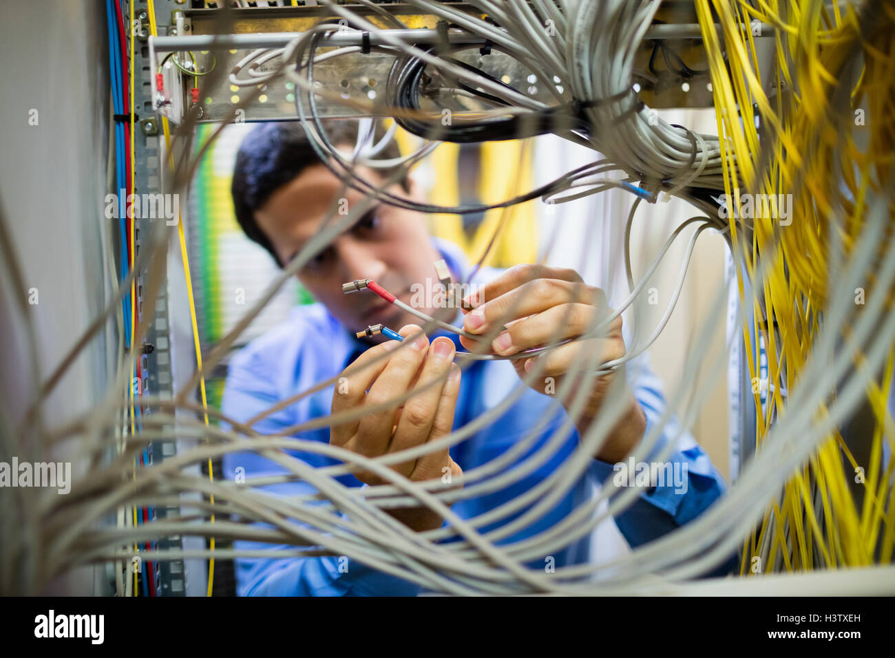 Technician fixing cable Stock Photo - Alamy Technician fixing cable Stock Photo - Alamy