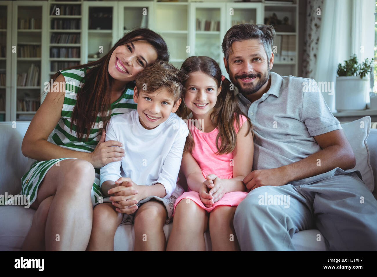 Family sitting together on sofa hi-res stock photography and images - Alamy