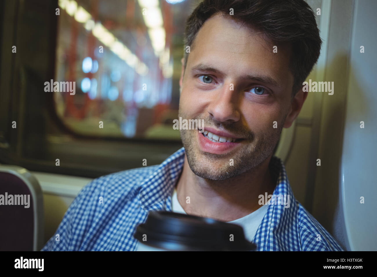 Portrait of man travelling in train Stock Photo - Alamy