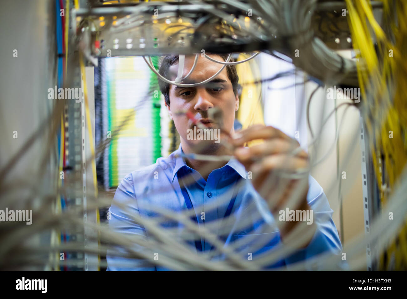 Technician fixing cable Stock Photo - Alamy