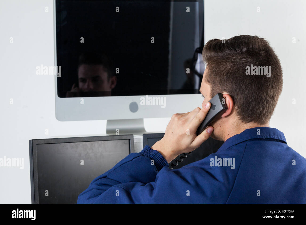 Security man looking at monitors hi-res stock photography and images ...