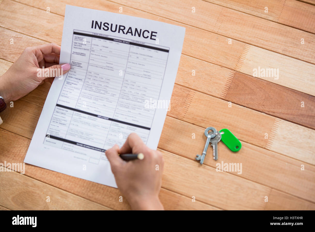 Businesswoman filling insurance contract form Stock Photo - Alamy