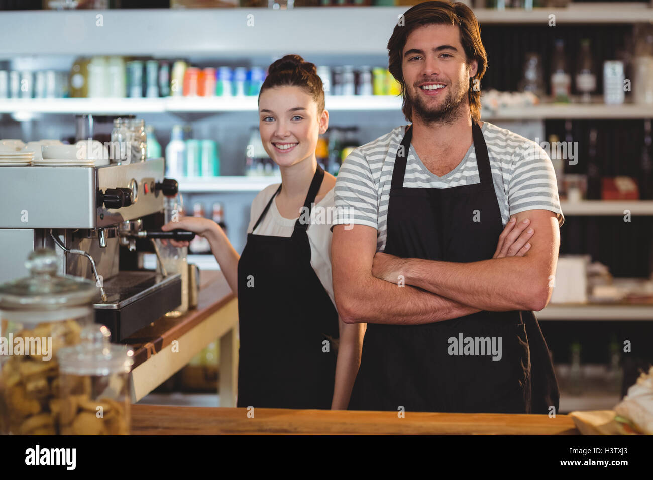 Portrait of waiter and waitress making cup of coffee at counter Stock ...