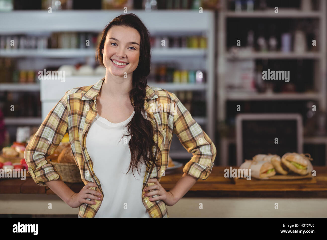 Portrait of woman standing behind the counter Stock Photo - Alamy