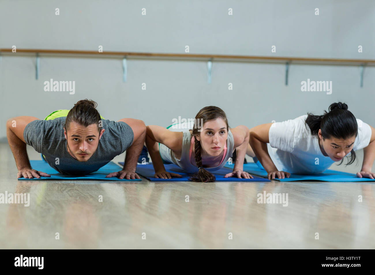 Group of fitness team doing push ups Stock Photo - Alamy