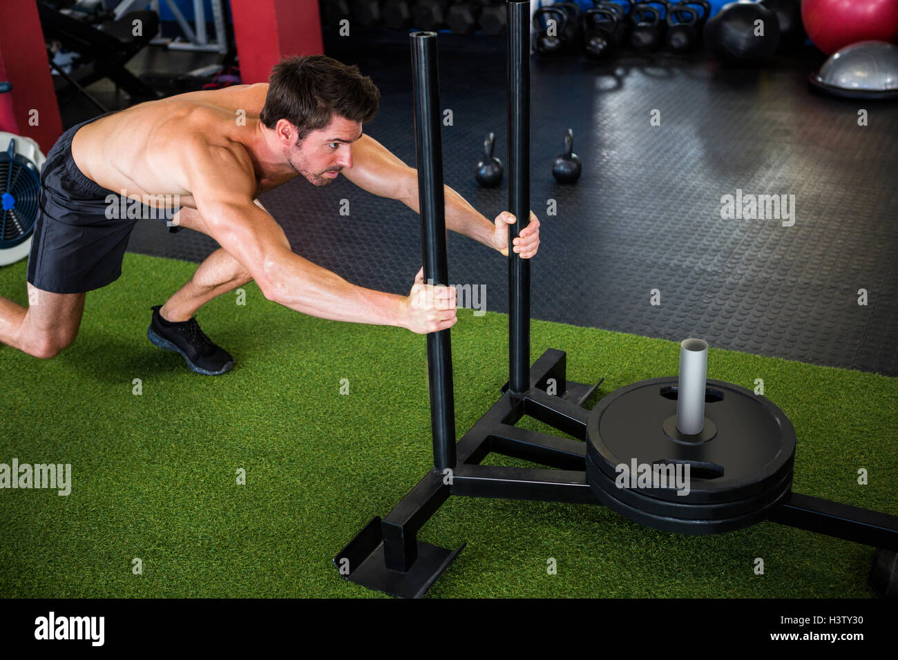 Shirtless man exercising in gym Stock Photo - Alamy