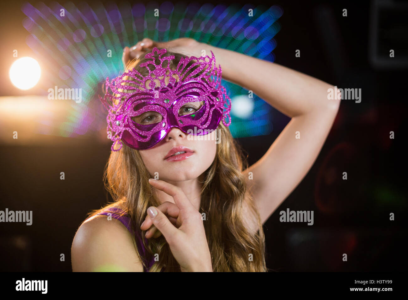 Woman posing with masquerade in bar Stock Photo - Alamy