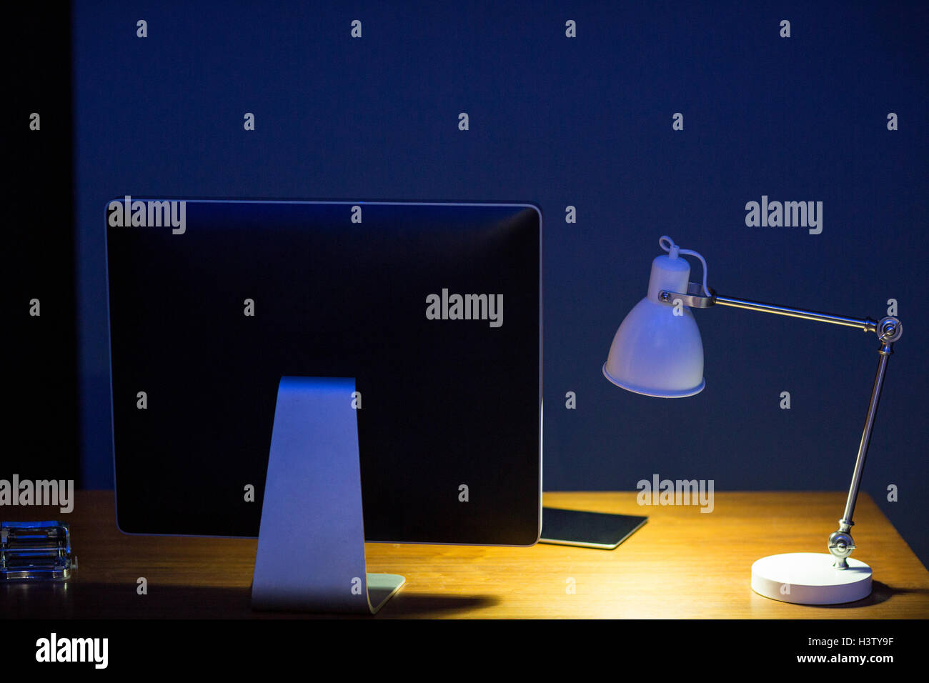 Close-up computer monitor and illuminated lamp Stock Photo - Alamy