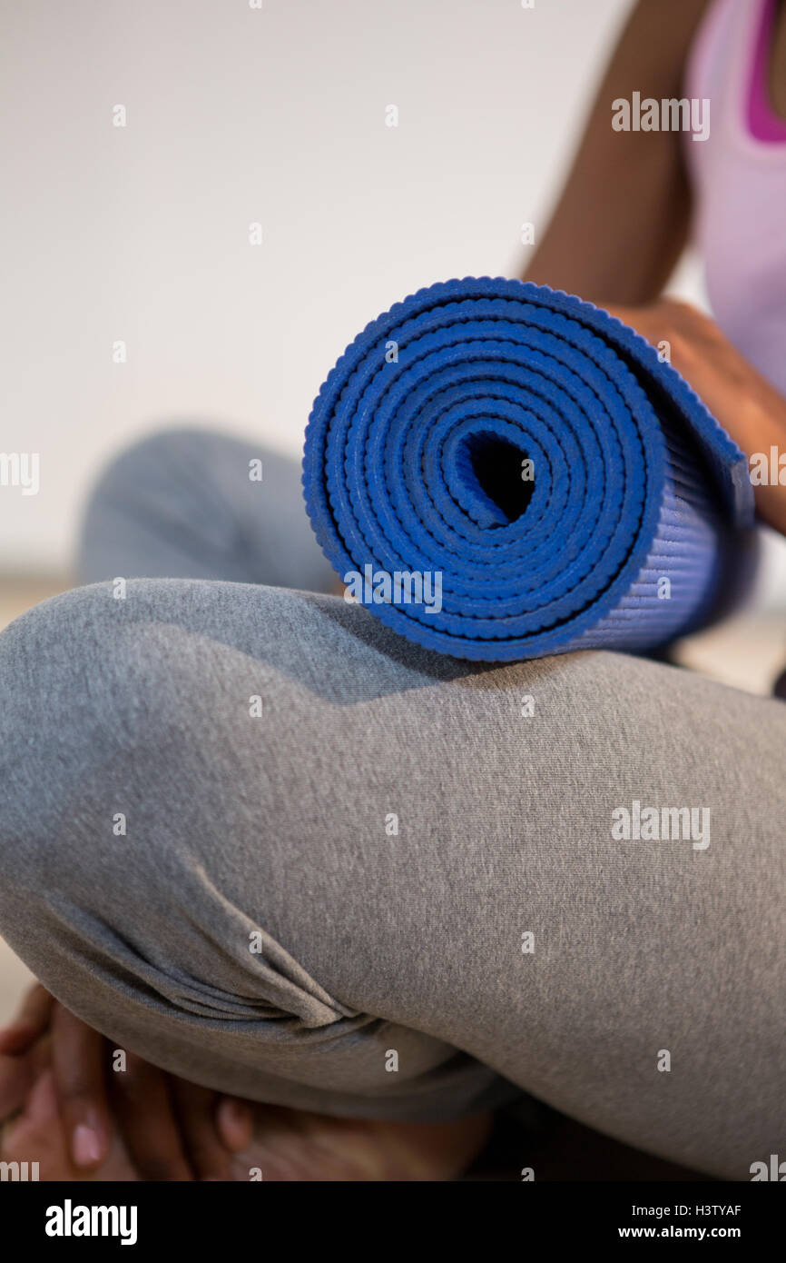 Woman holding exercise mat Stock Photo - Alamy