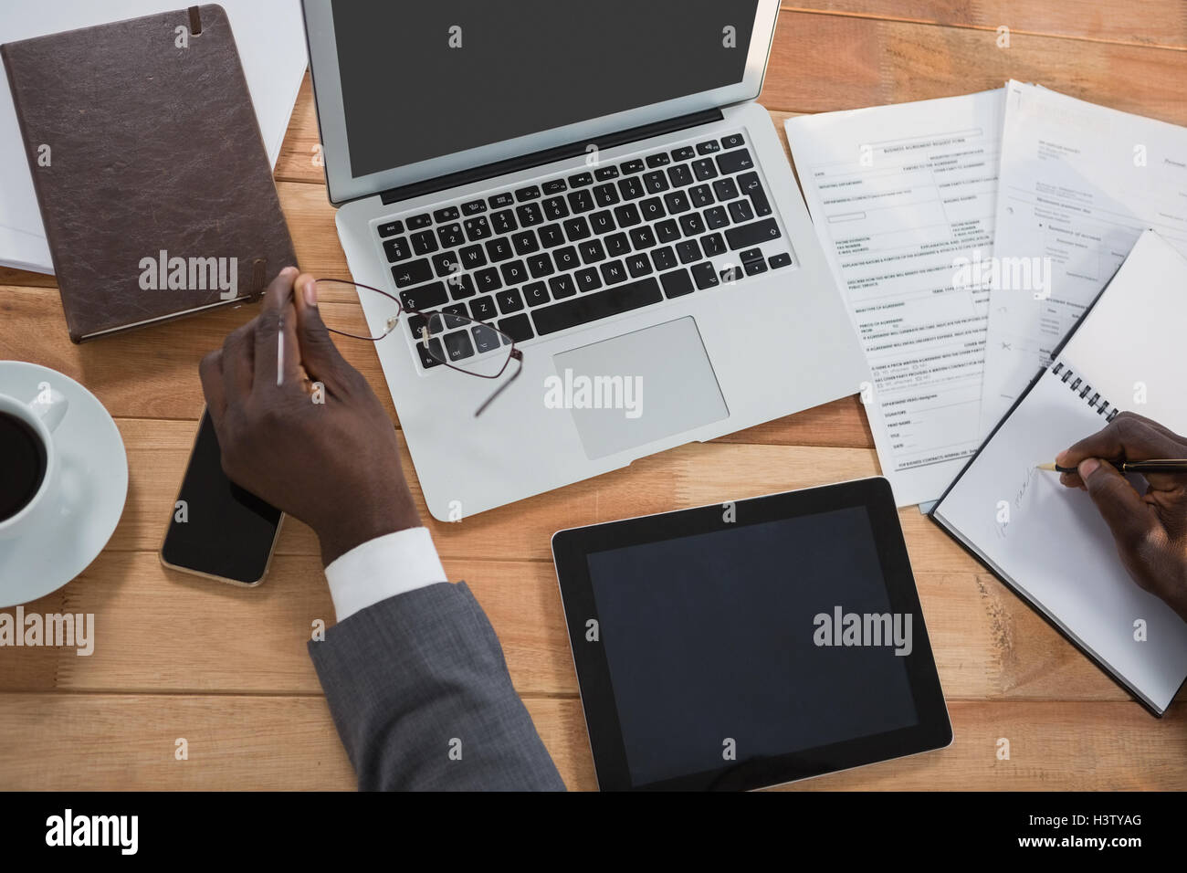 Businessmans hand over laptop, digital tablet, mobile phone and ...