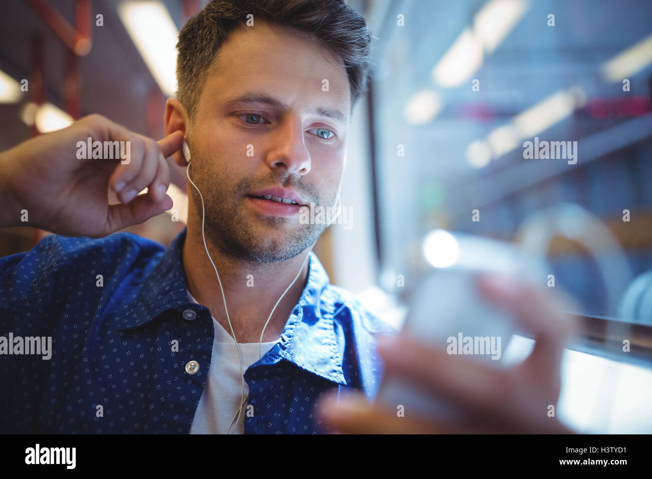 Handsome man listening music on mobile phone Stock Photo - Alamy