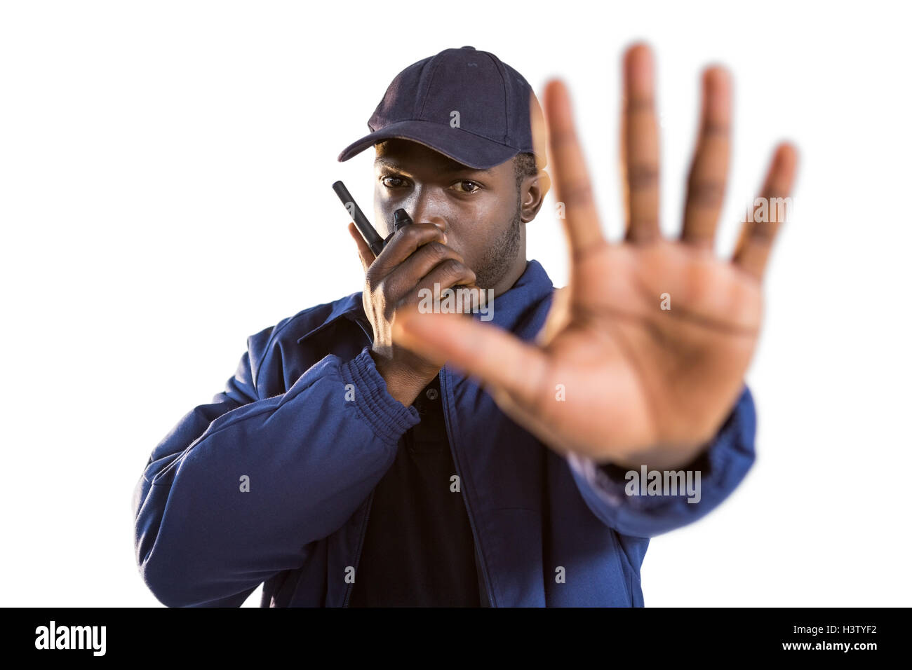 Confident security talking on walkie talkie and making hand stop ...