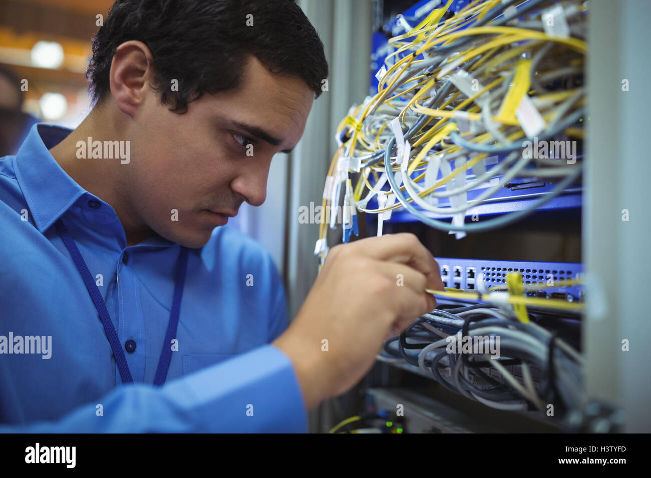 Technician checking cables in a rack mounted server Stock Photo - Alamy