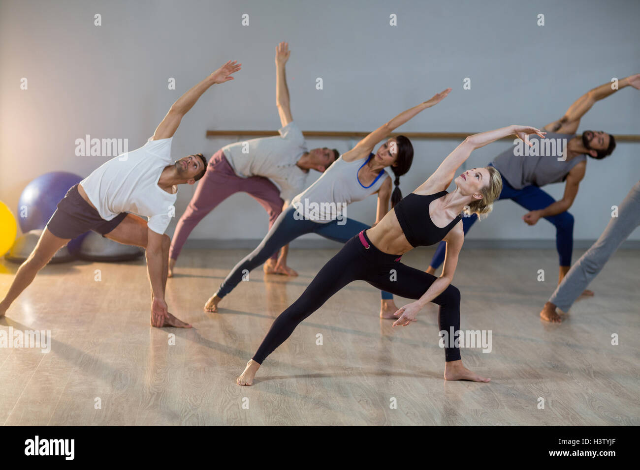 Group of people performing stretching exercise Stock Photo - Alamy