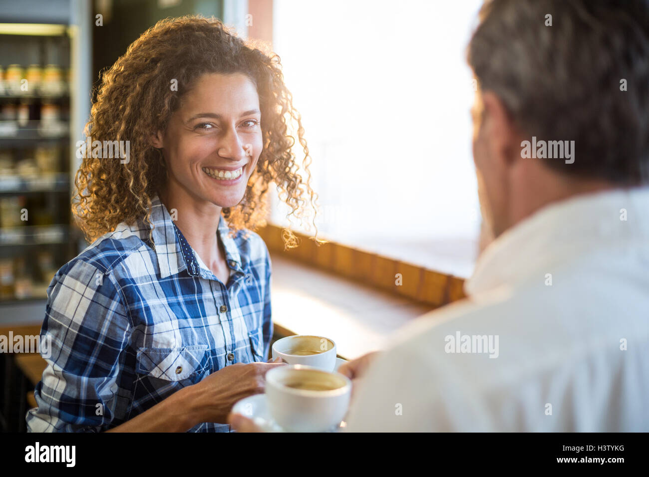 Smiling couple having coffee Stock Photo - Alamy
