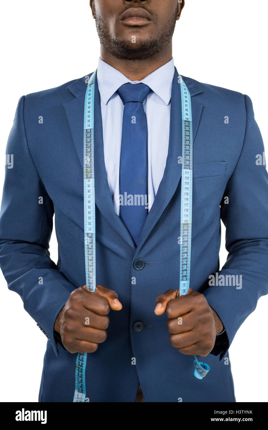 Businessman holding a measuring tape around is neck Stock Photo - Alamy