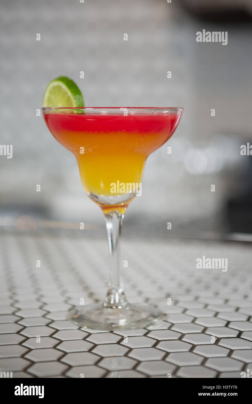 Glass of cocktail on counter Stock Photo - Alamy
