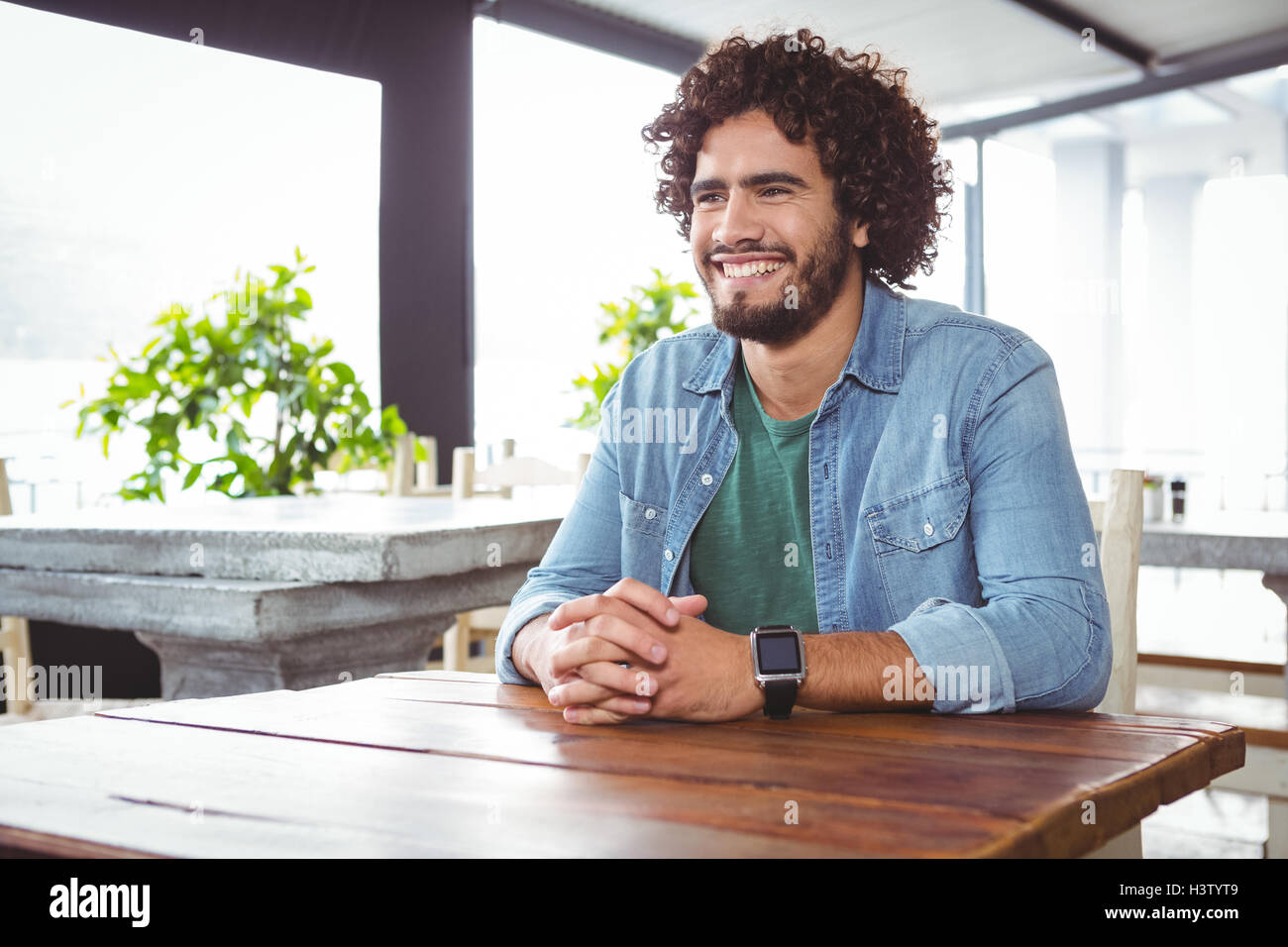 Man sitting and smiling Stock Photo - Alamy