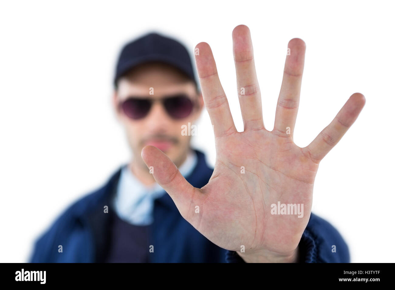 Confident security officer making stop gesture Stock Photo - Alamy